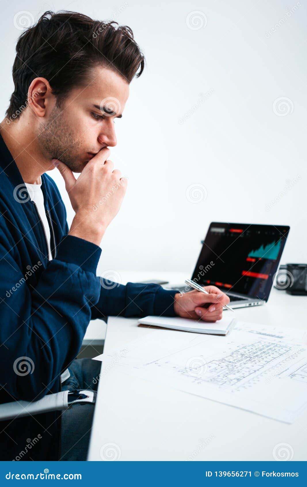 Concentrated Building Designer Working with Drawing Plan and Computer ...