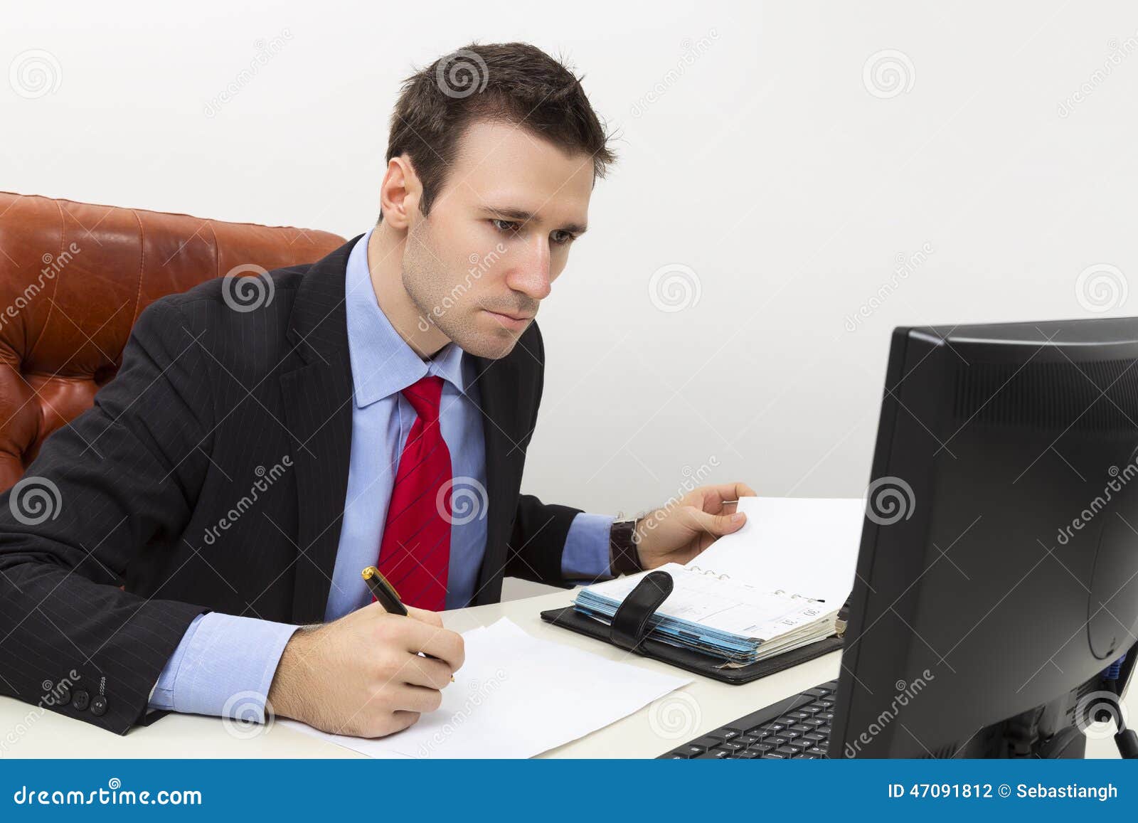 Concentrated Business Man Filling a Paper Document Stock Photo - Image ...