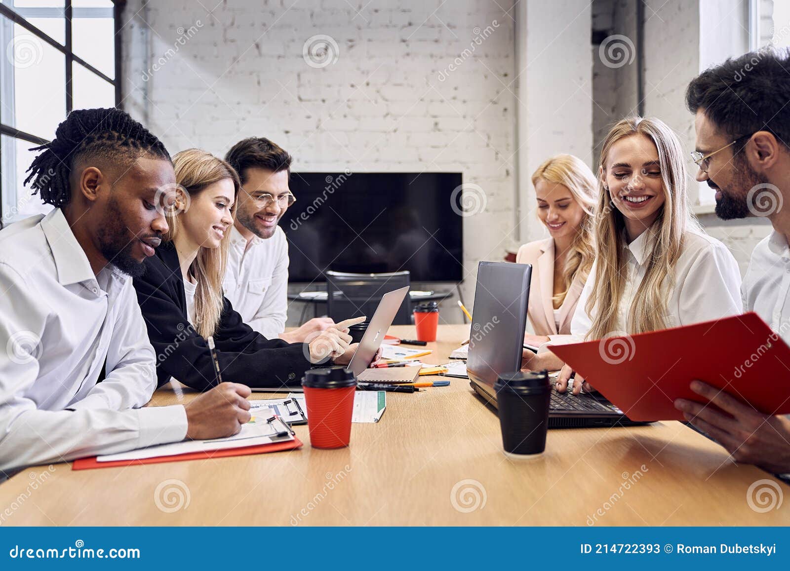 Concentrated Business People Communicating with Each Other while ... Concentrated Business People Communicating with Each Other while ...