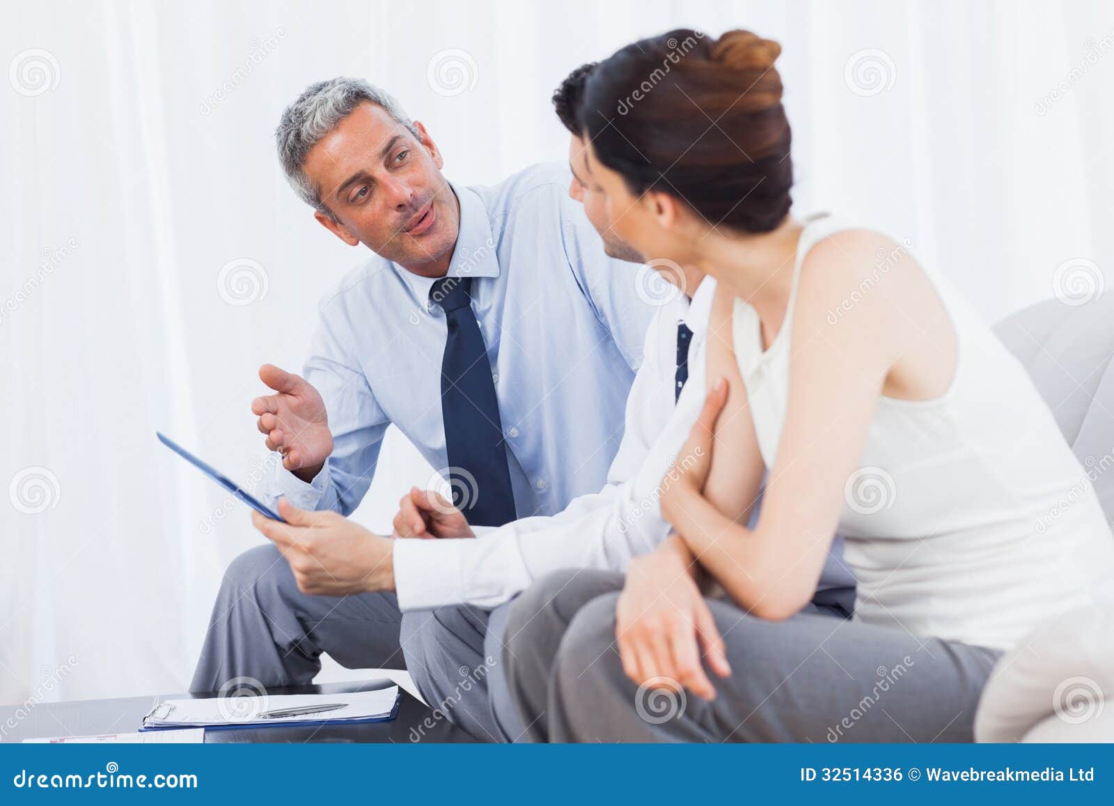 Concentrated Business People Talking about Files on Sofa Stock Photo ...