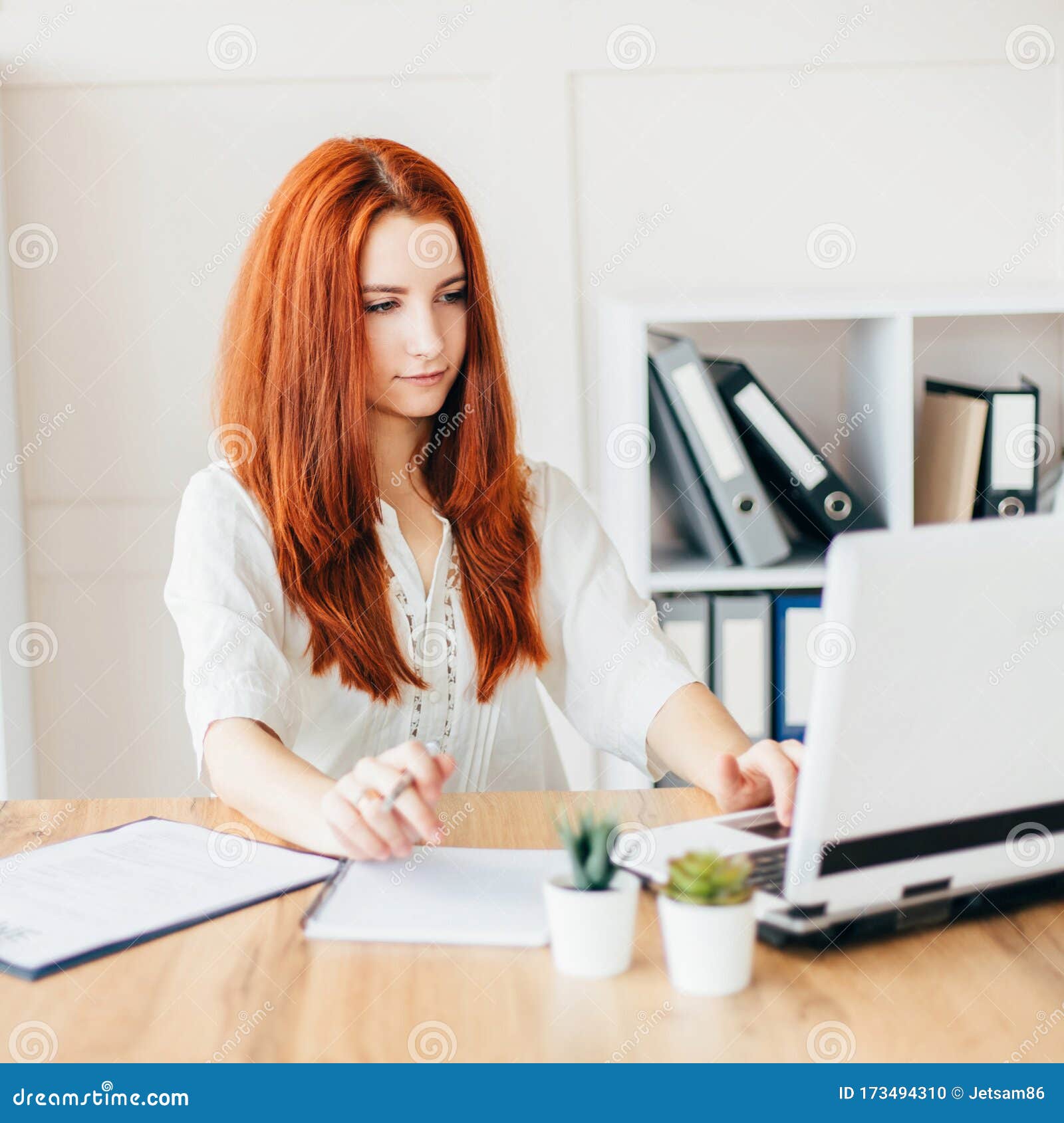 Business Woman Reading Documents and Using Laptop Stock Photo - Image ...