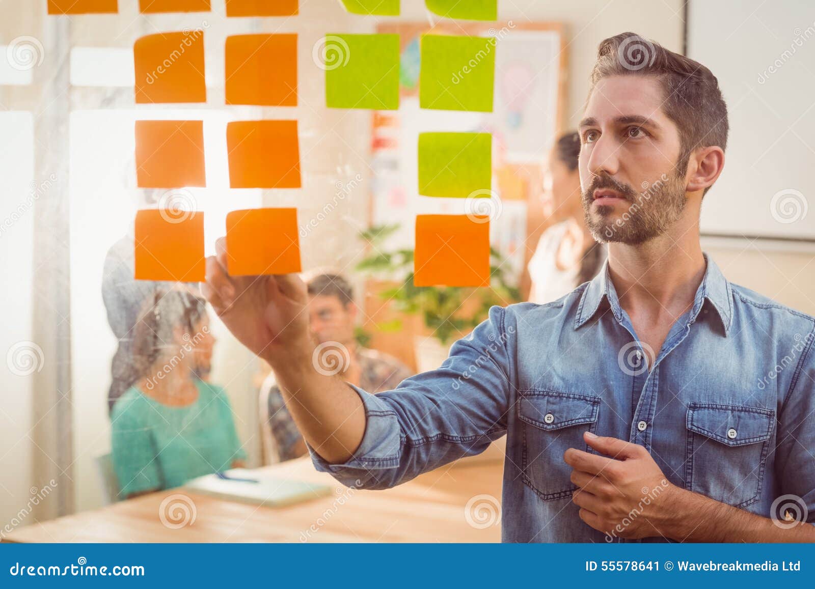 Concentrated Businessman Looking Post Its on the Wall Stock Image ...