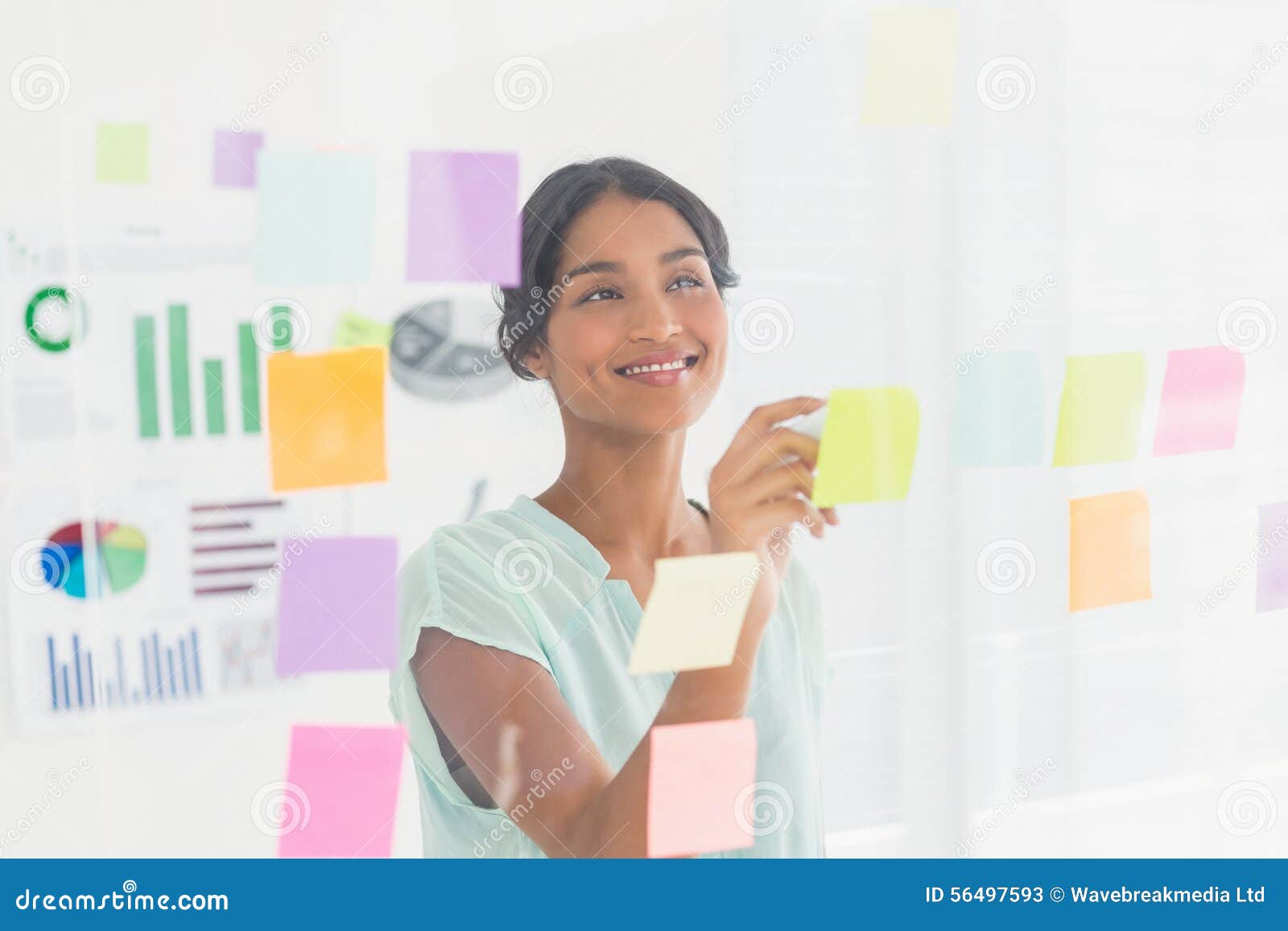 Concentrated Businesswoman Looking Post Its on the Wall Stock Image ...