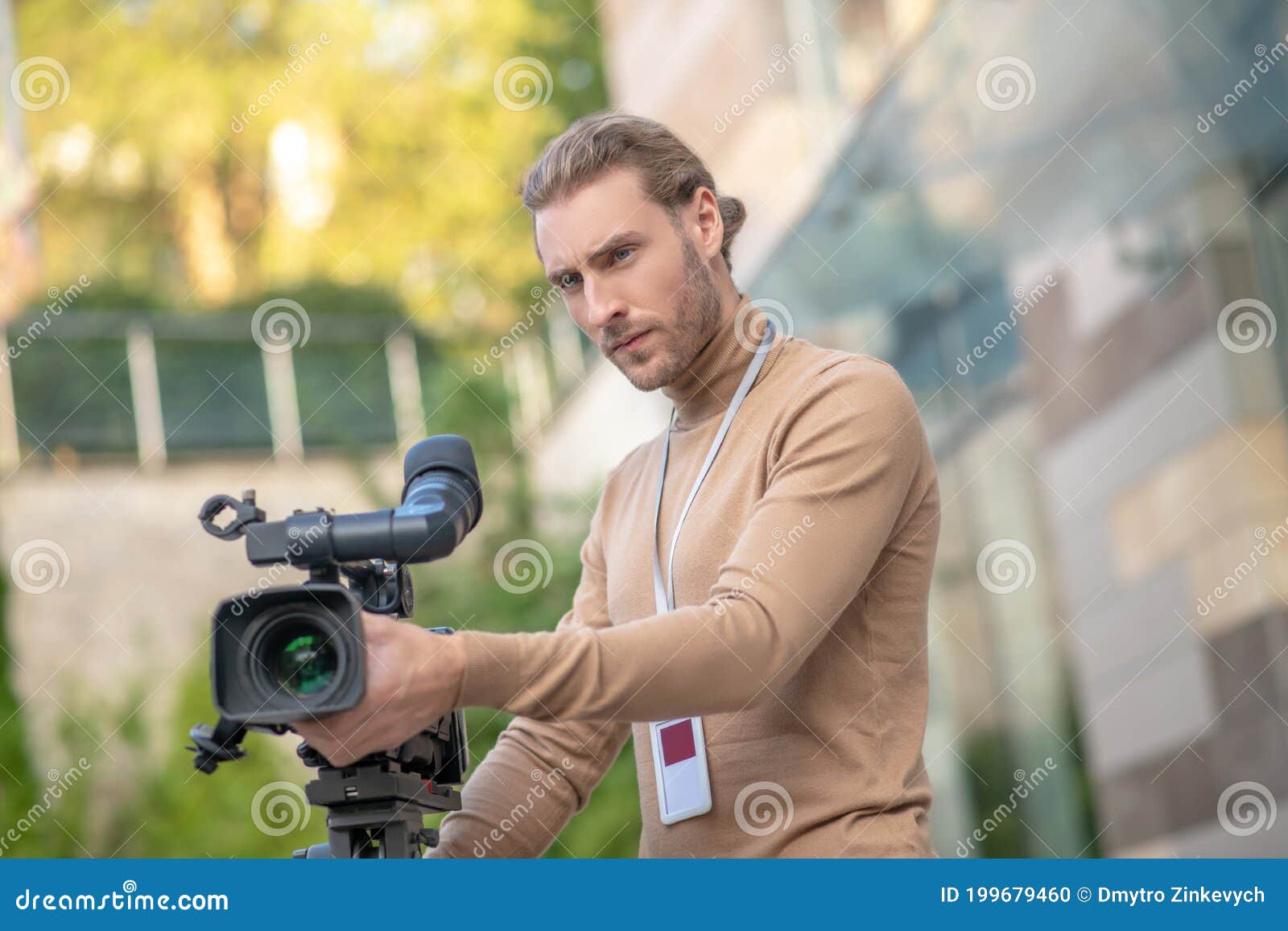 Concentrated Cameraman Standing Behind Camera, Getting Ready for ...