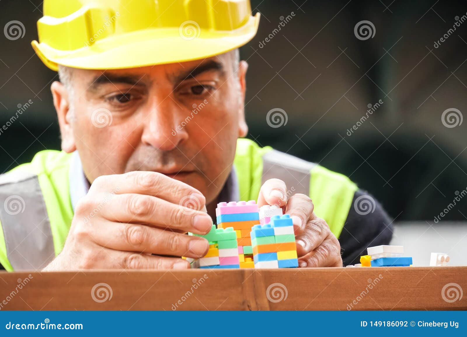 Construction Worker Using Colourful Toy Bricks Stock Photo - Image of ...