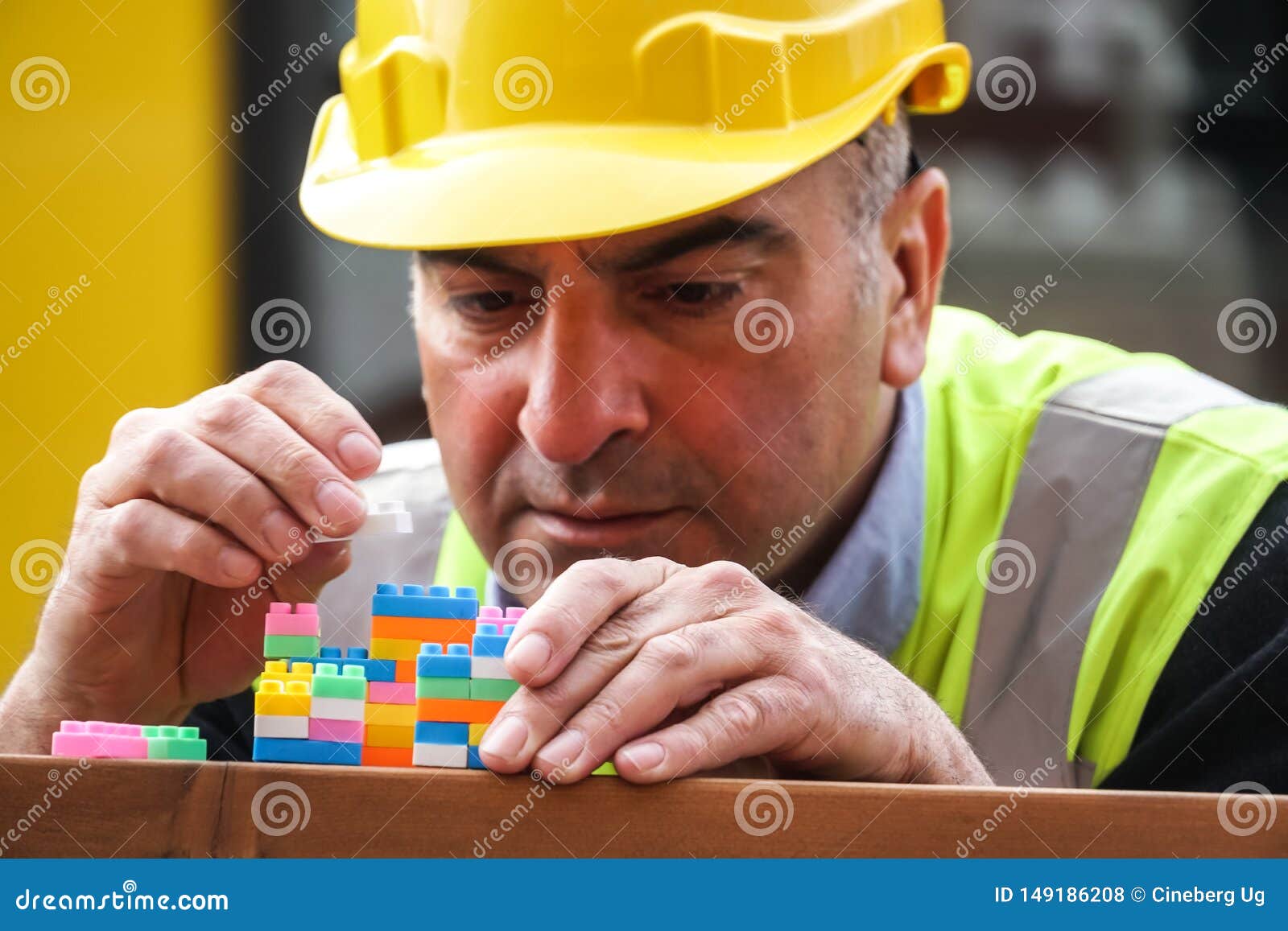 Construction Worker Using Colourful Toy Bricks Stock Photo - Image of ...