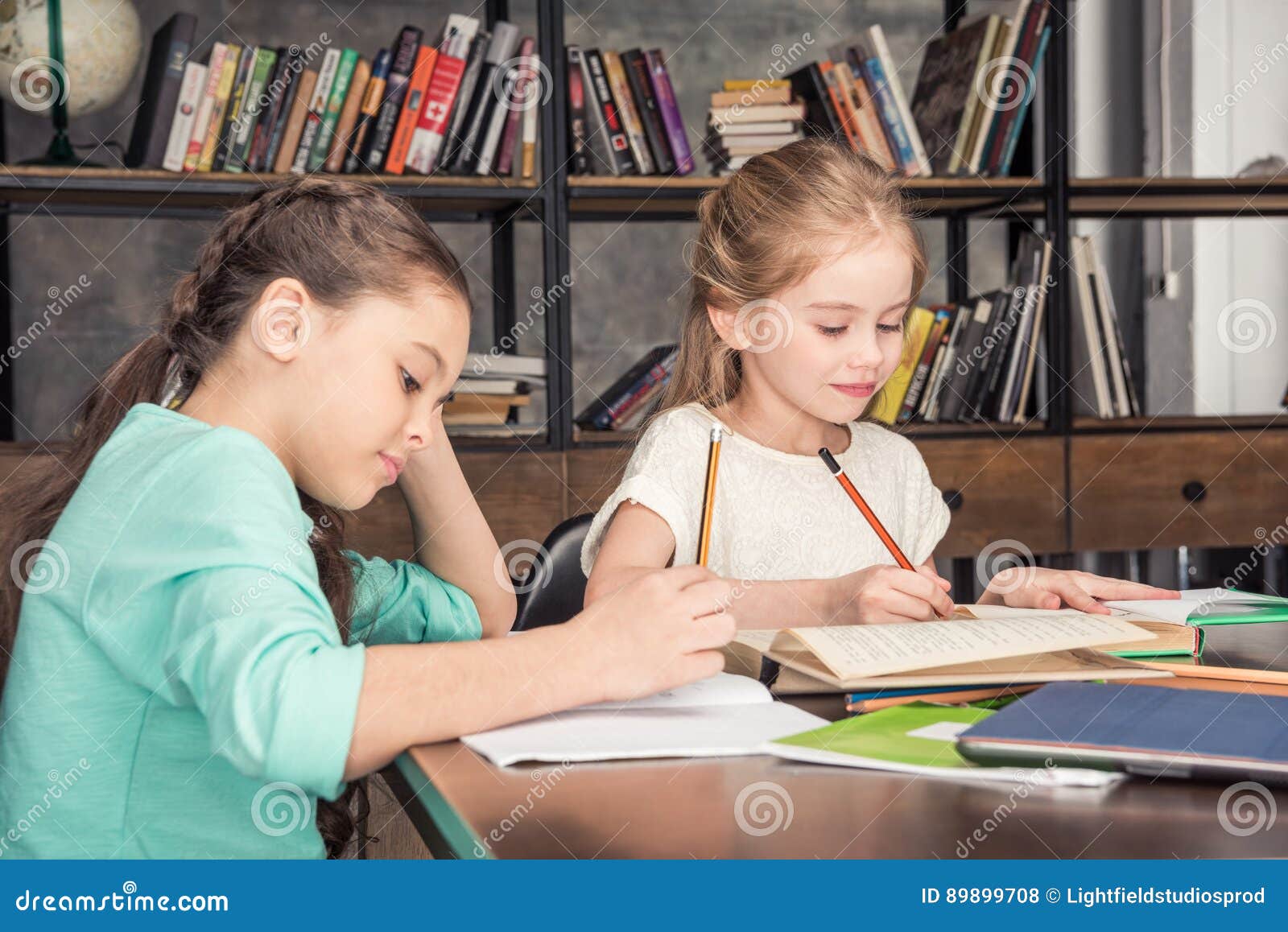 Concentrated Classmates Doing Homework Together in Library Stock Photo ...