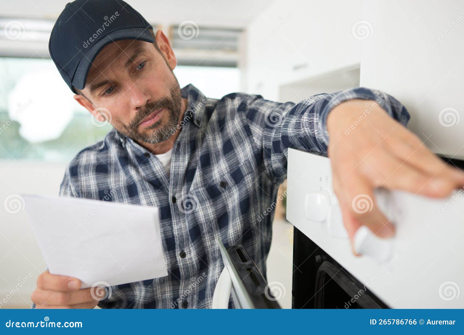 Concentrated Contractor Reading Instructions for Oven Stock Photo ...