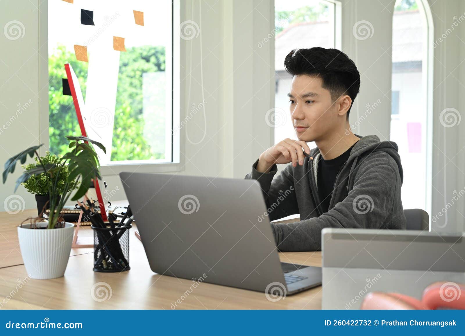 Concentrated Creative Man Working on Design Project at Bright Modern ...