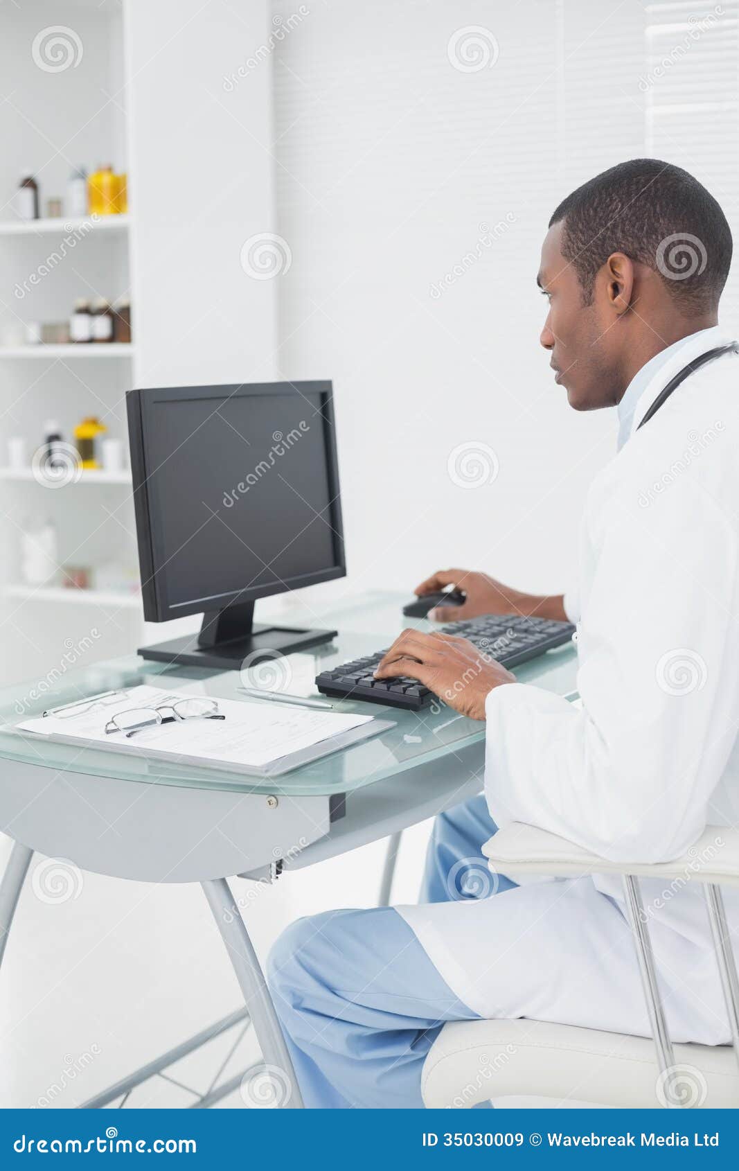 Concentrated Doctor Using Computer at Medical Office Stock Image ...
