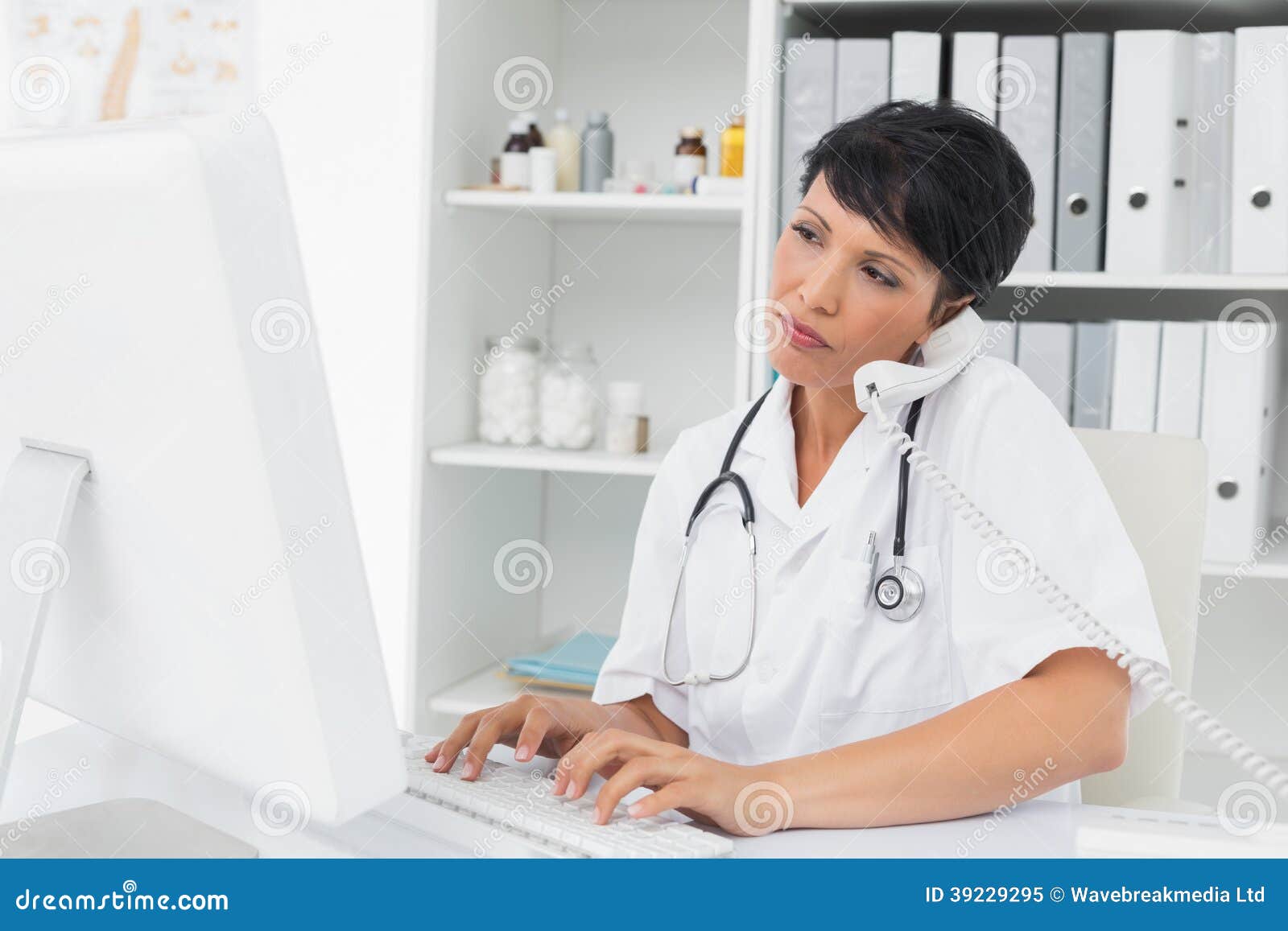 Concentrated Doctor Using Computer and Telephone Stock Image - Image of ...