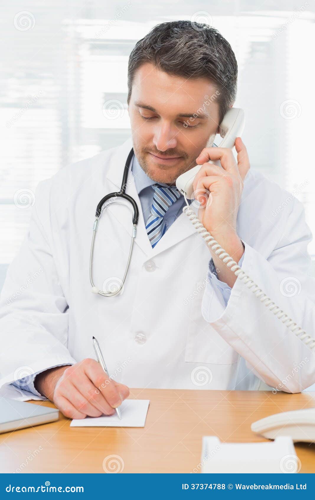 Concentrated Doctor Using Phone while Writing Notes Stock Photo - Image ...