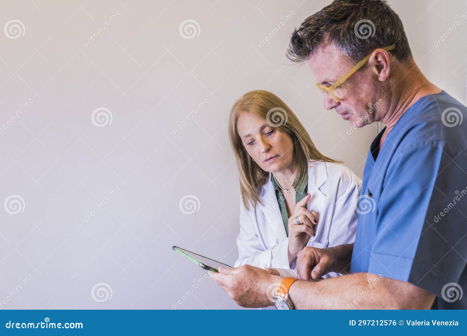 Concentrated Doctors Using Pad Device while Talking about a Patient ...