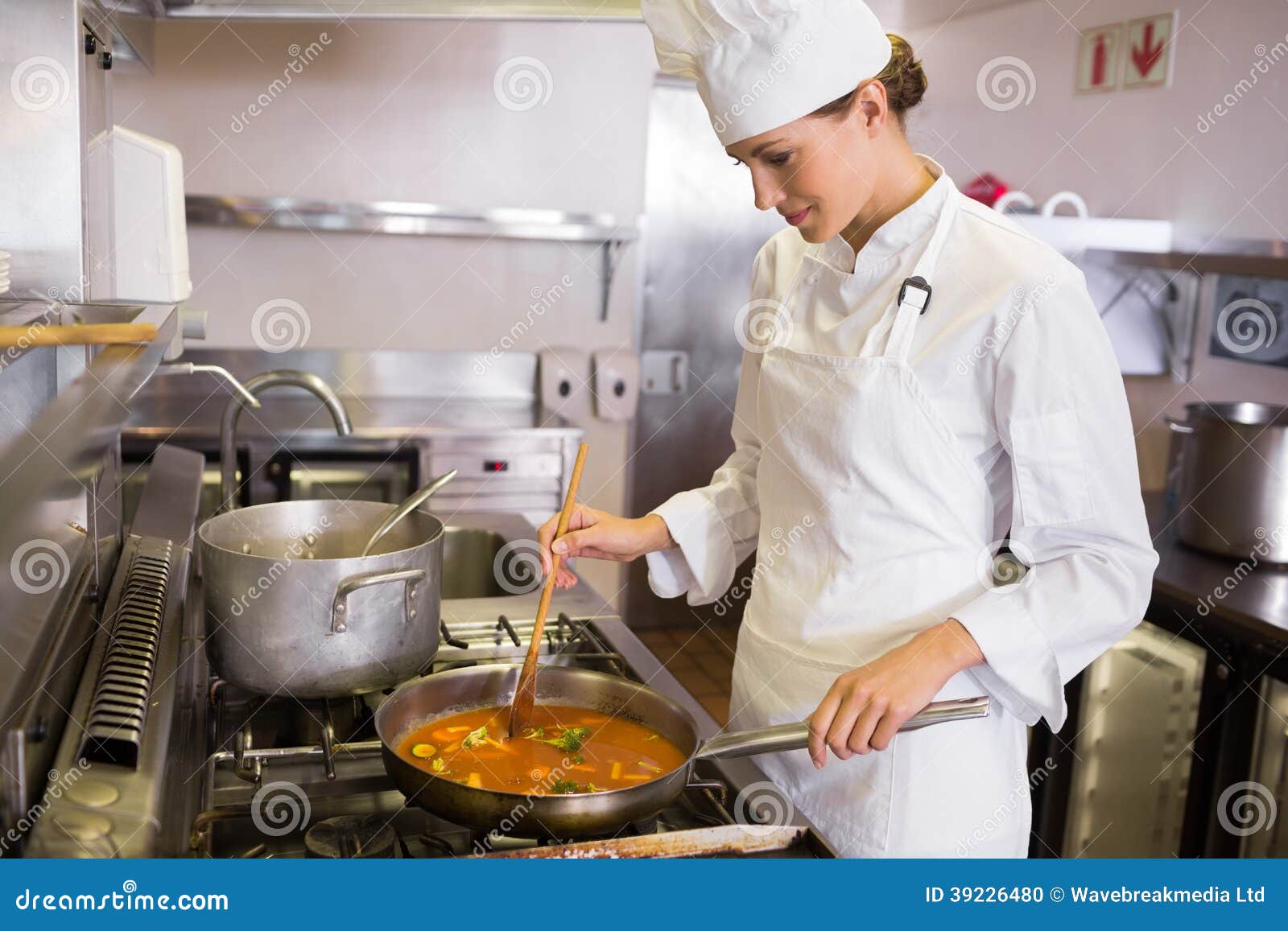 Concentrated Female Cook Preparing Food in Kitchen Stock Photo - Image ...