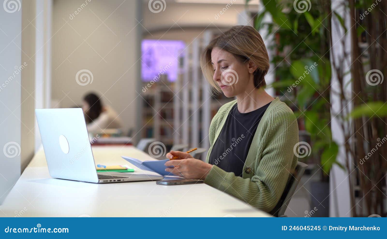 Concentrated Female University Professor Checking Course Schedule while ...