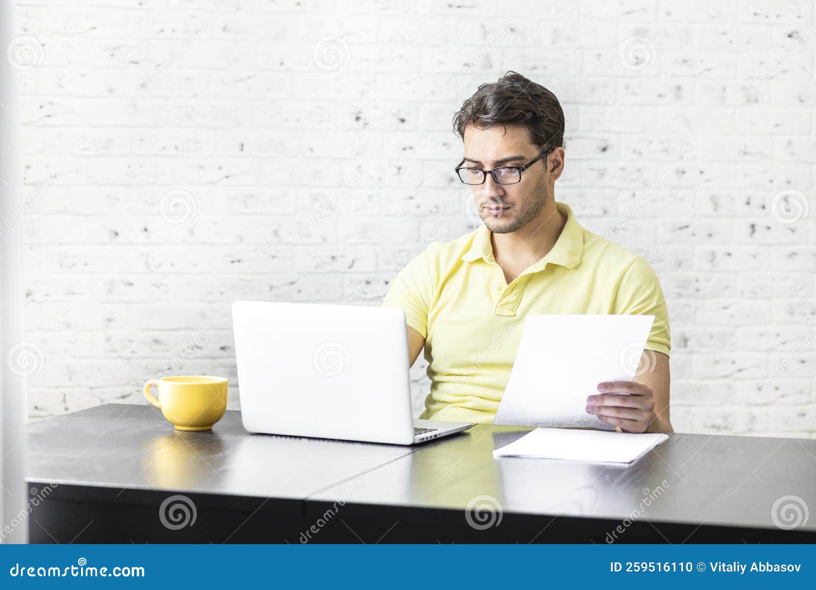 Concentrated Freelancer Sitting at the Table at Home and Working ...