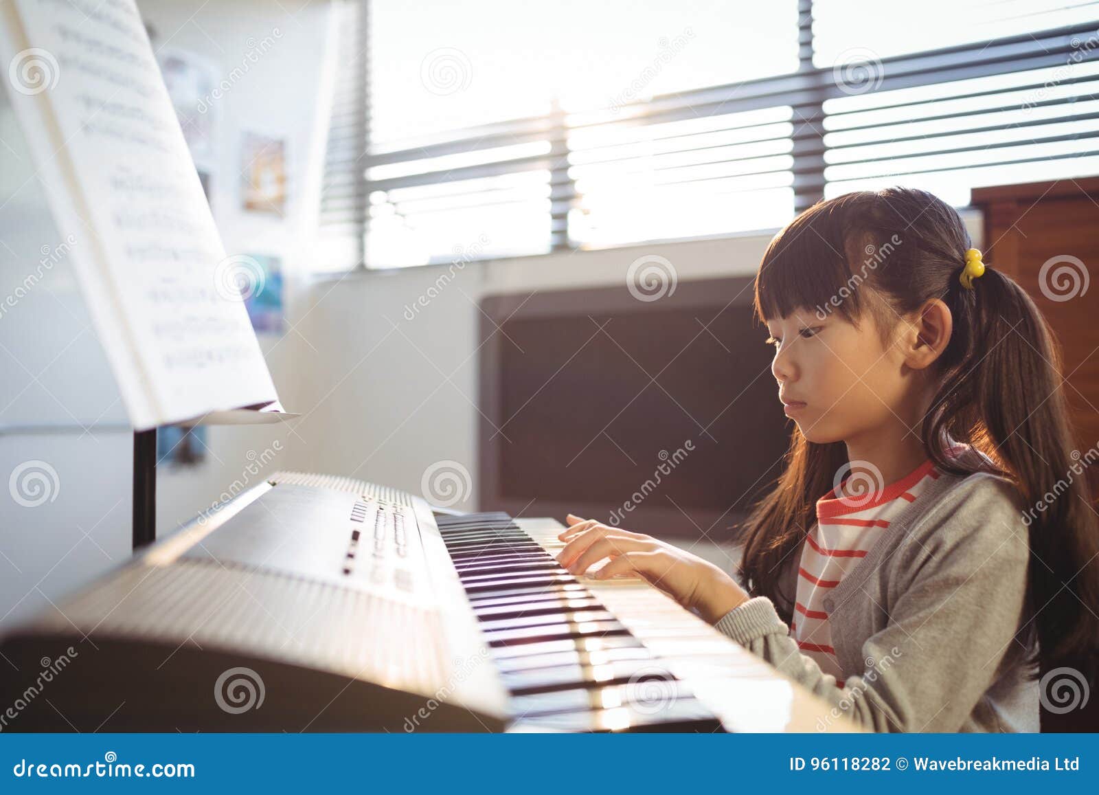 Concentrated Girl Practicing Piano in Class Stock Photo - Image of ...