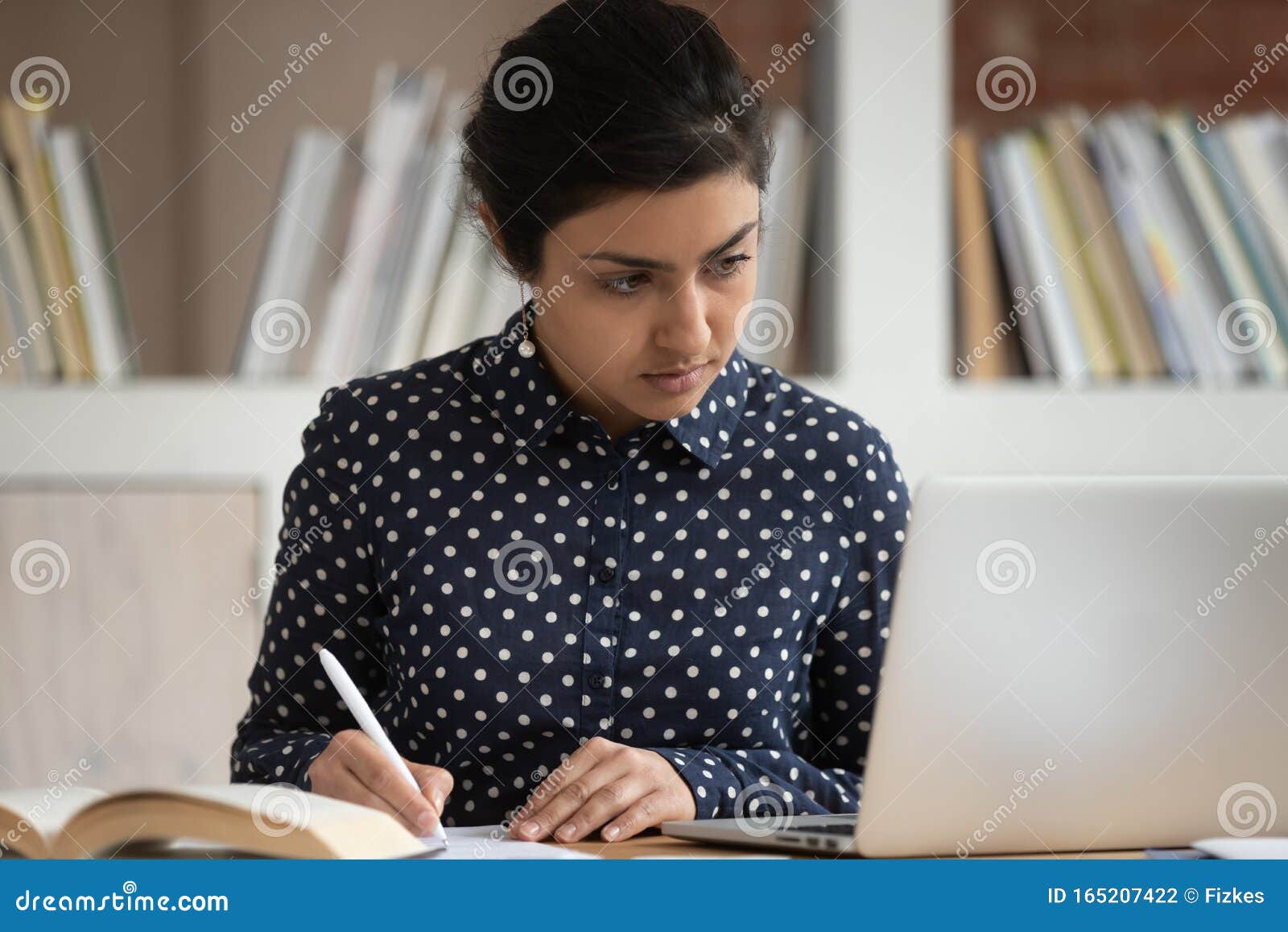 Concentrated Indian Female Student Reading Scientific Article. Stock ...
