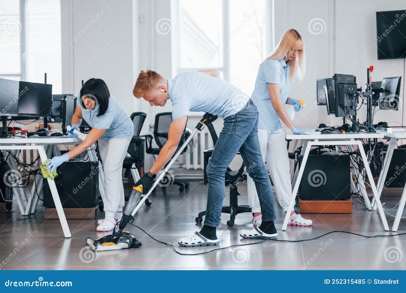 Concentrated at Job. Group of Workers Clean Modern Office Together at ...