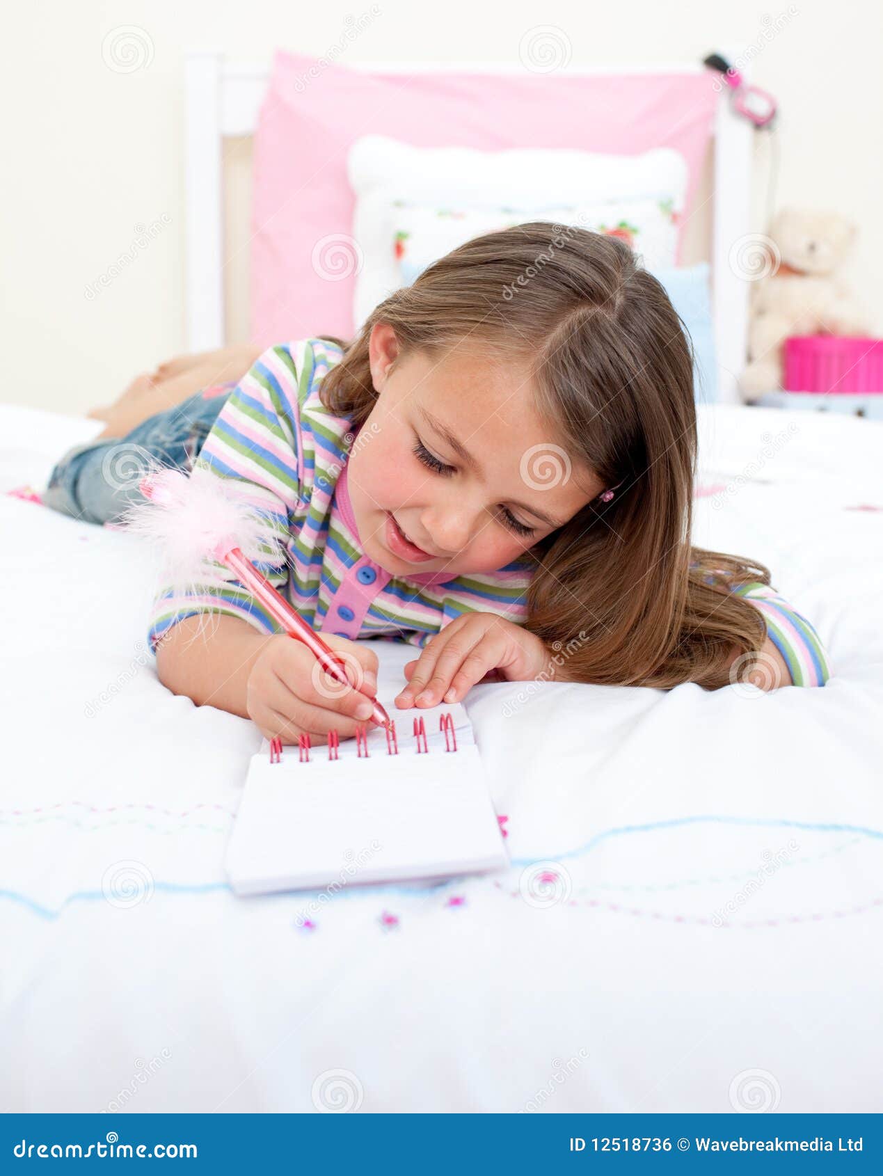 Concentrated Little Girl Writing on a Notebook Stock Photo - Image of ...