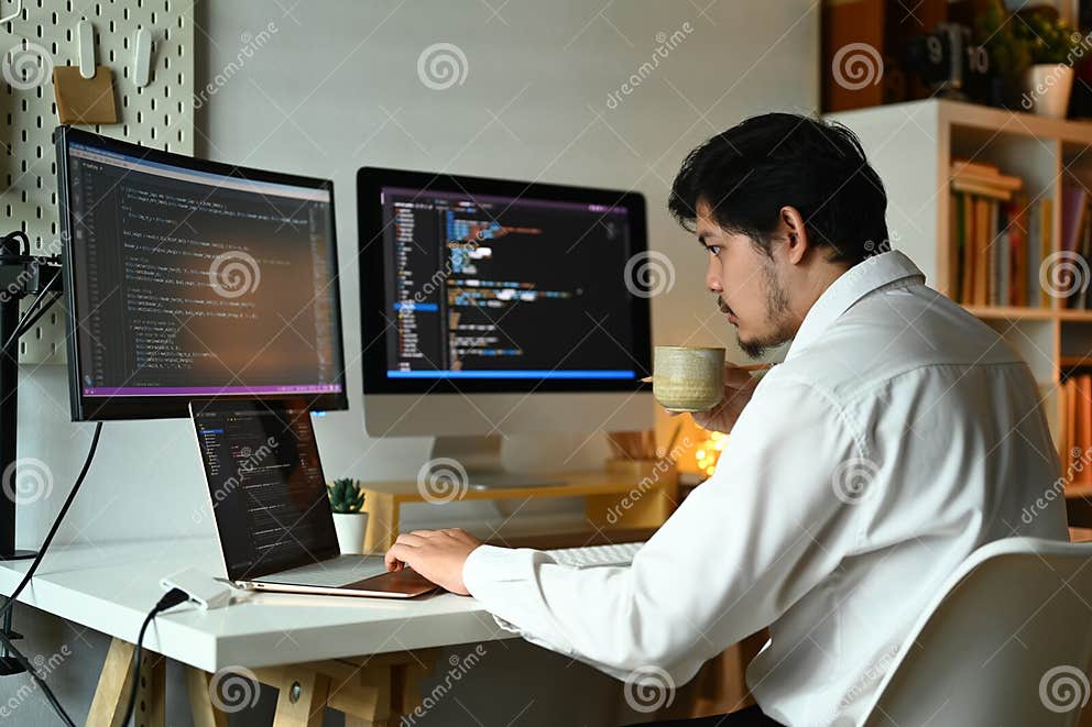 Concentrated Male Web Developer Working with Coded Data on Computer Screen. Programming and ...