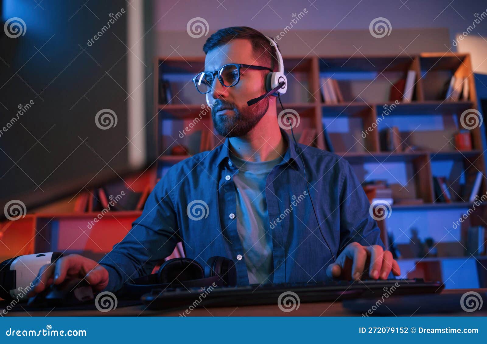 Concentrated Man is Sitting by a Computer Indoors at Home. Neon ...