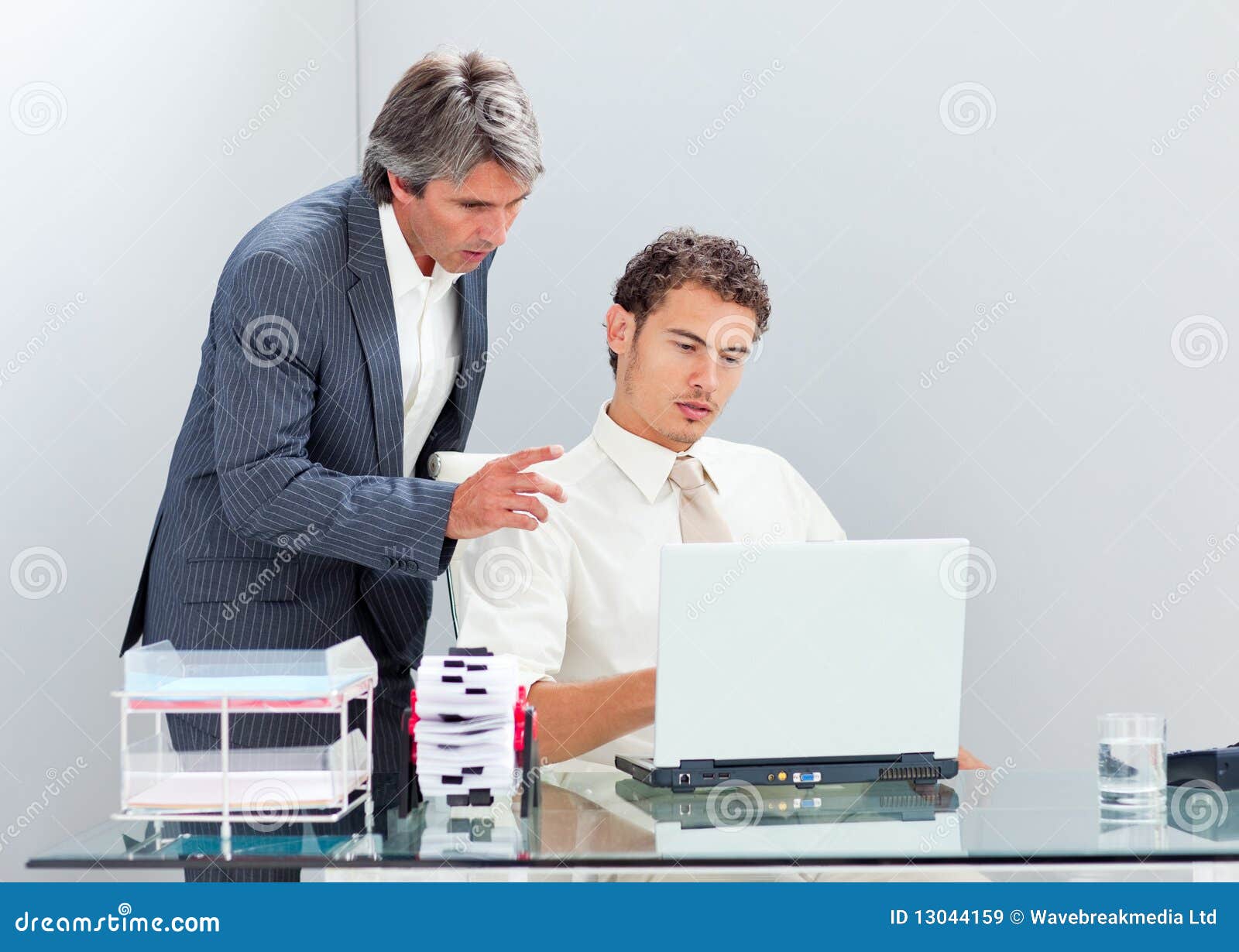 Concentrated Manager Helping His Colleague Work Stock Image - Image of ...