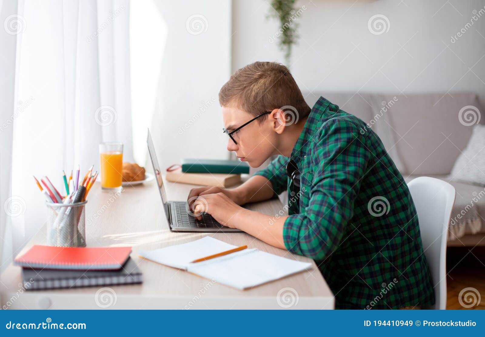 Concentrated Nerd Boy Using Laptop, Working on Project at Home Stock ...