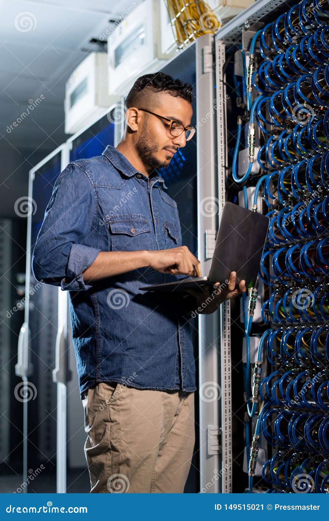 Concentrated Network Engineer Examining Database Server Stock Image ...