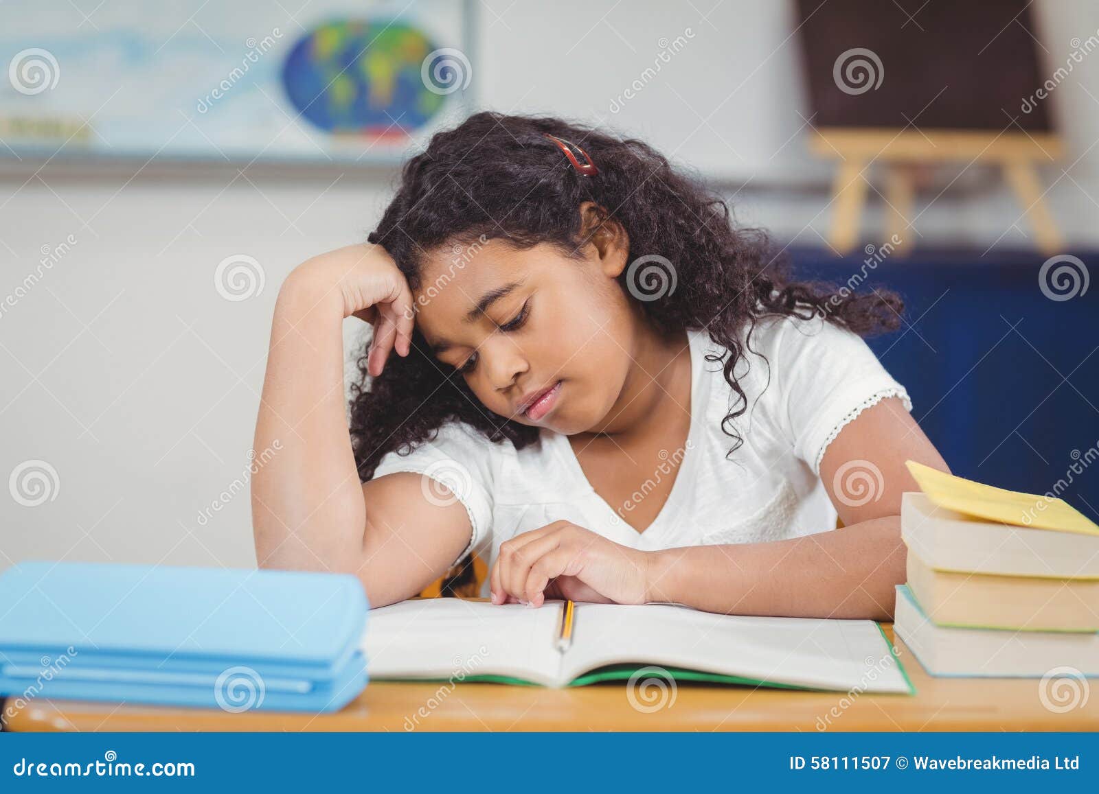 Concentrated Pupil Reading Notepad in a Classroom Stock Image - Image ...