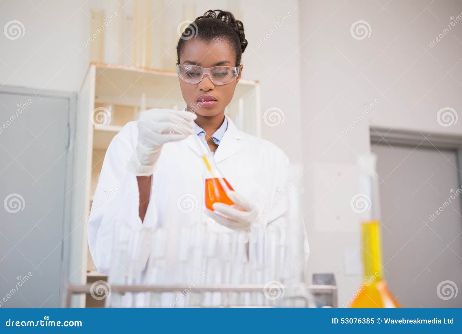 Concentrated Scientist Examining Orange Fluid Stock Image - Image of ...