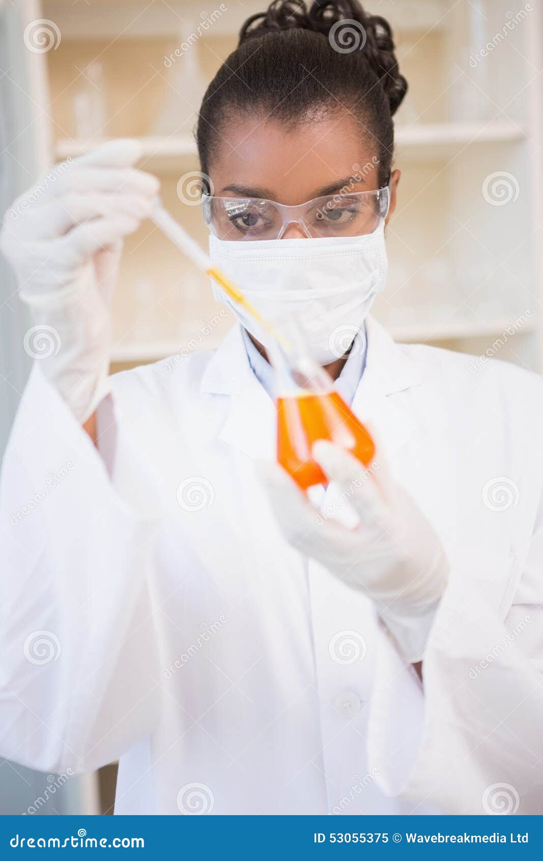 Concentrated Scientist Examining Orange Fluid with Pipette Stock Image ...