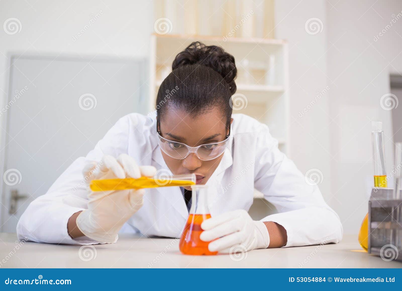 Concentrated Scientist Pouring Orange Fluid Stock Photo - Image of ...