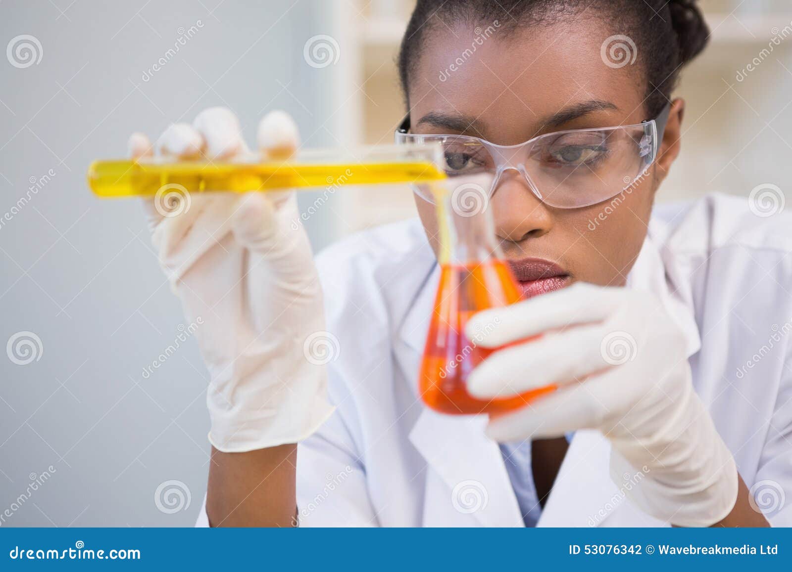Concentrated Scientist Pouring Orange Fluid Stock Photo - Image of ...