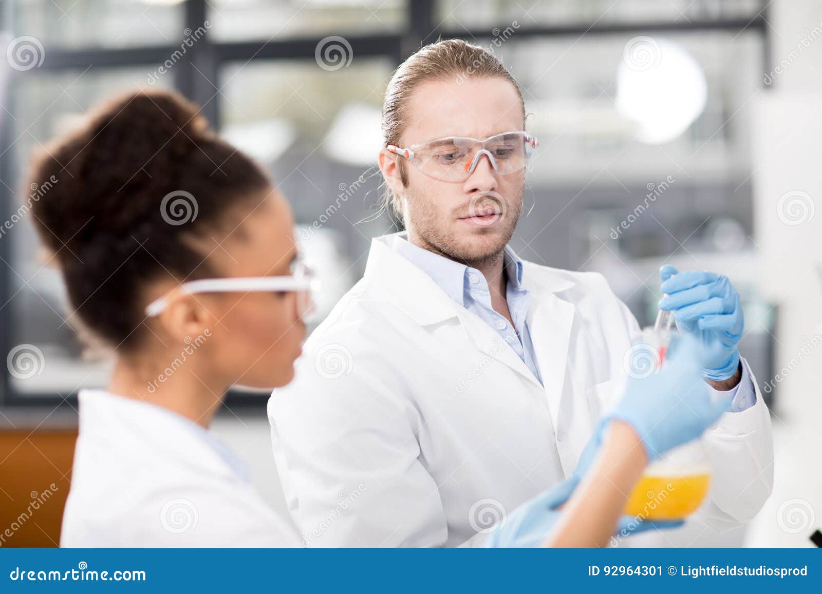 Concentrated Scientists Analyzing Test Tube in Laboratory Stock Image ...