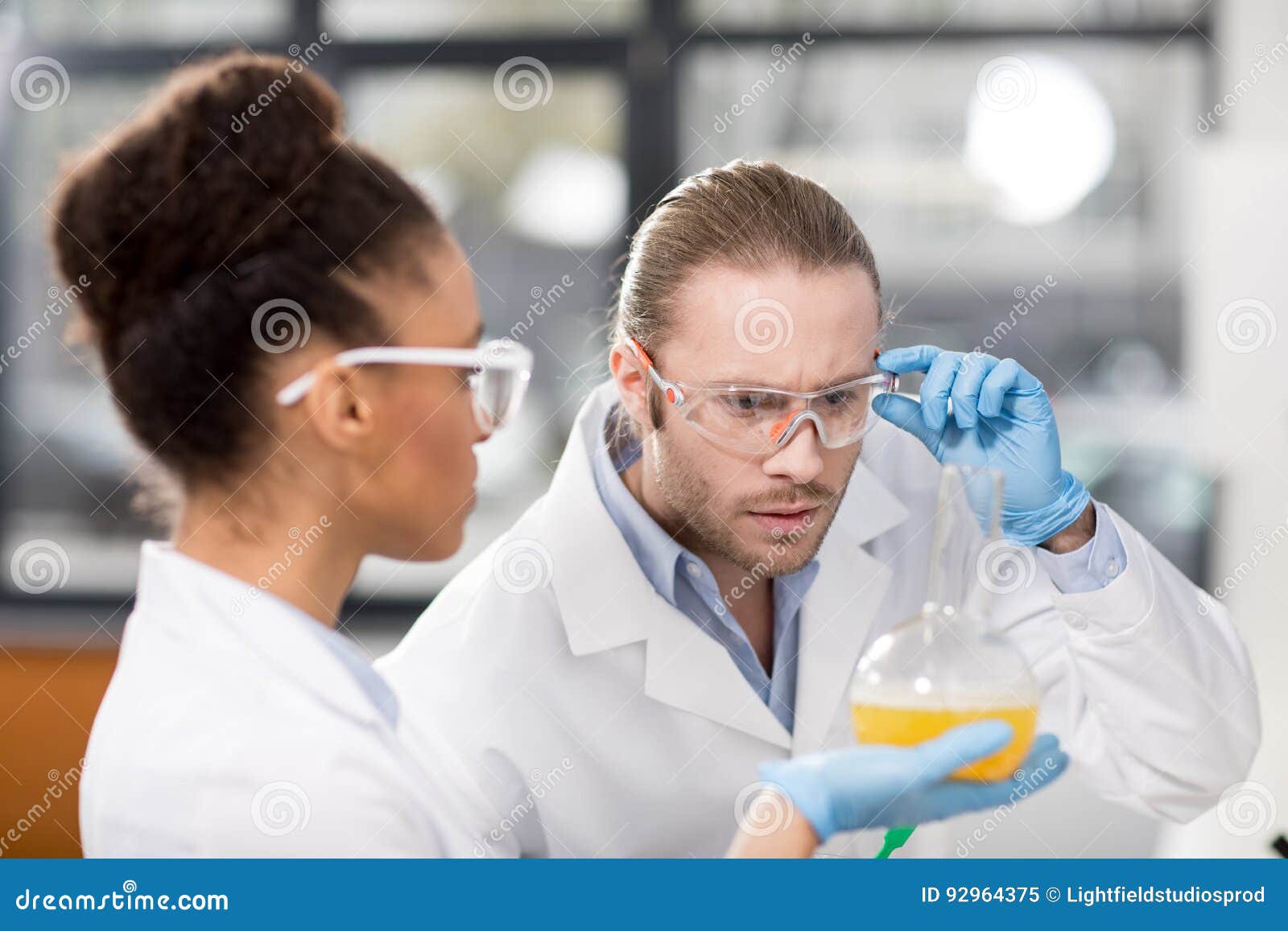 Concentrated Scientists Analyzing Test Tube in Laboratory Stock Image ...
