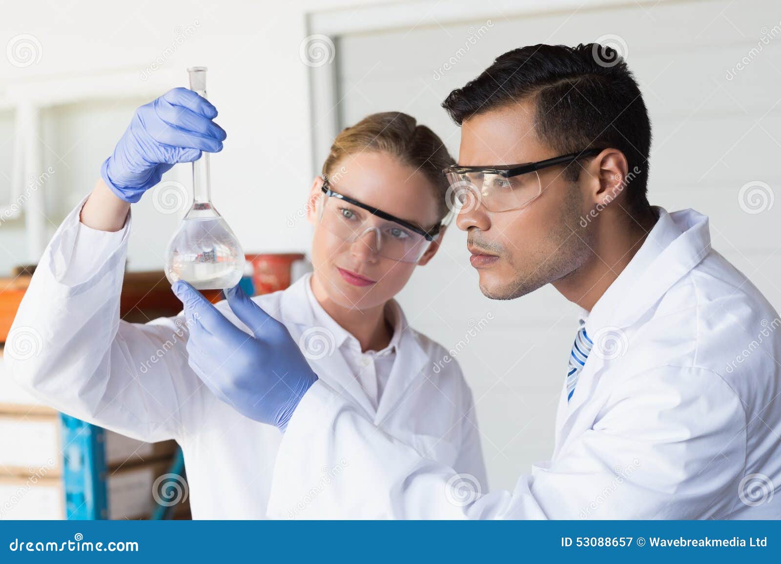 Concentrated Scientists Looking at Beaker Stock Image - Image of ...
