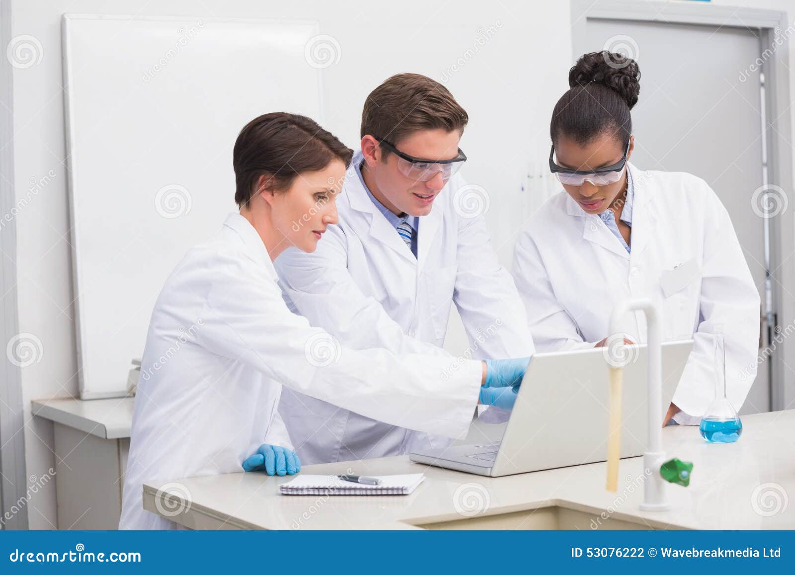 Concentrated Scientists Working Together with Laptop Stock Photo ...
