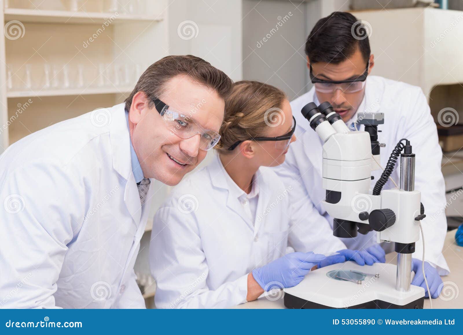 Concentrated Scientists Working Together with Microscope Stock Photo ...