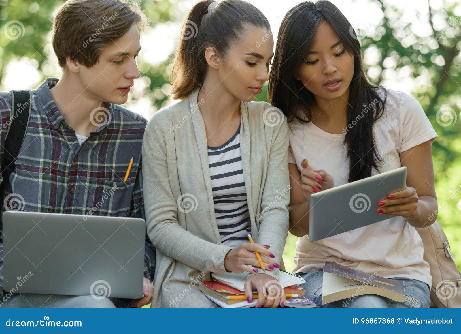 Concentrated Students Sitting and Studying Outdoors Stock Photo - Image ...