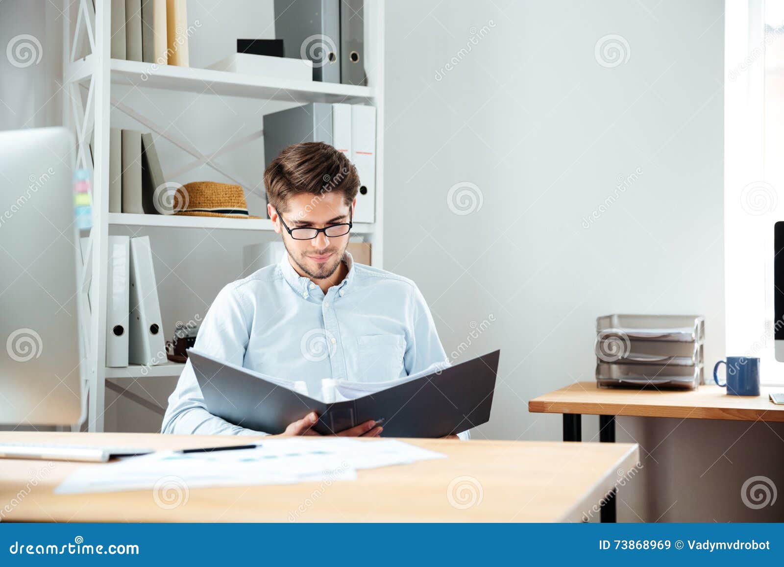Concentrated Young Businessman Working with Documents in Folder Stock ...