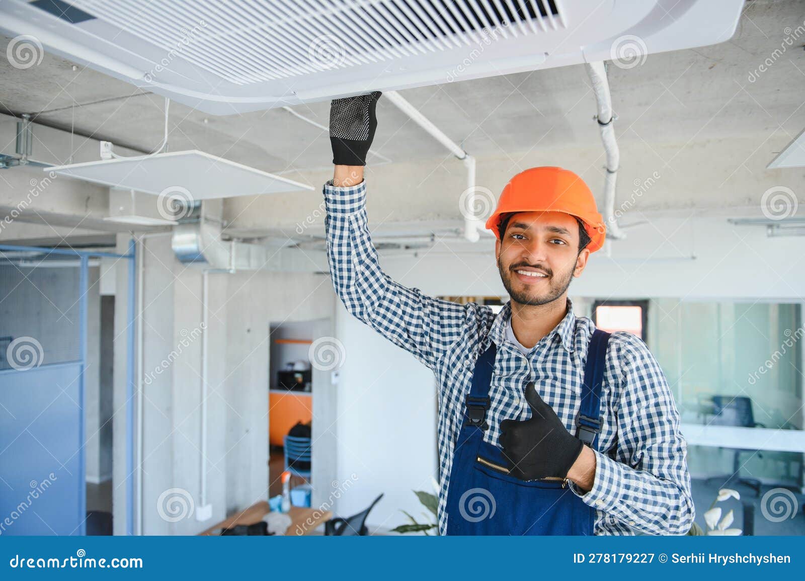 Concentrated Young Indian Engineer Setting Up Air Conditioner. Stock ...