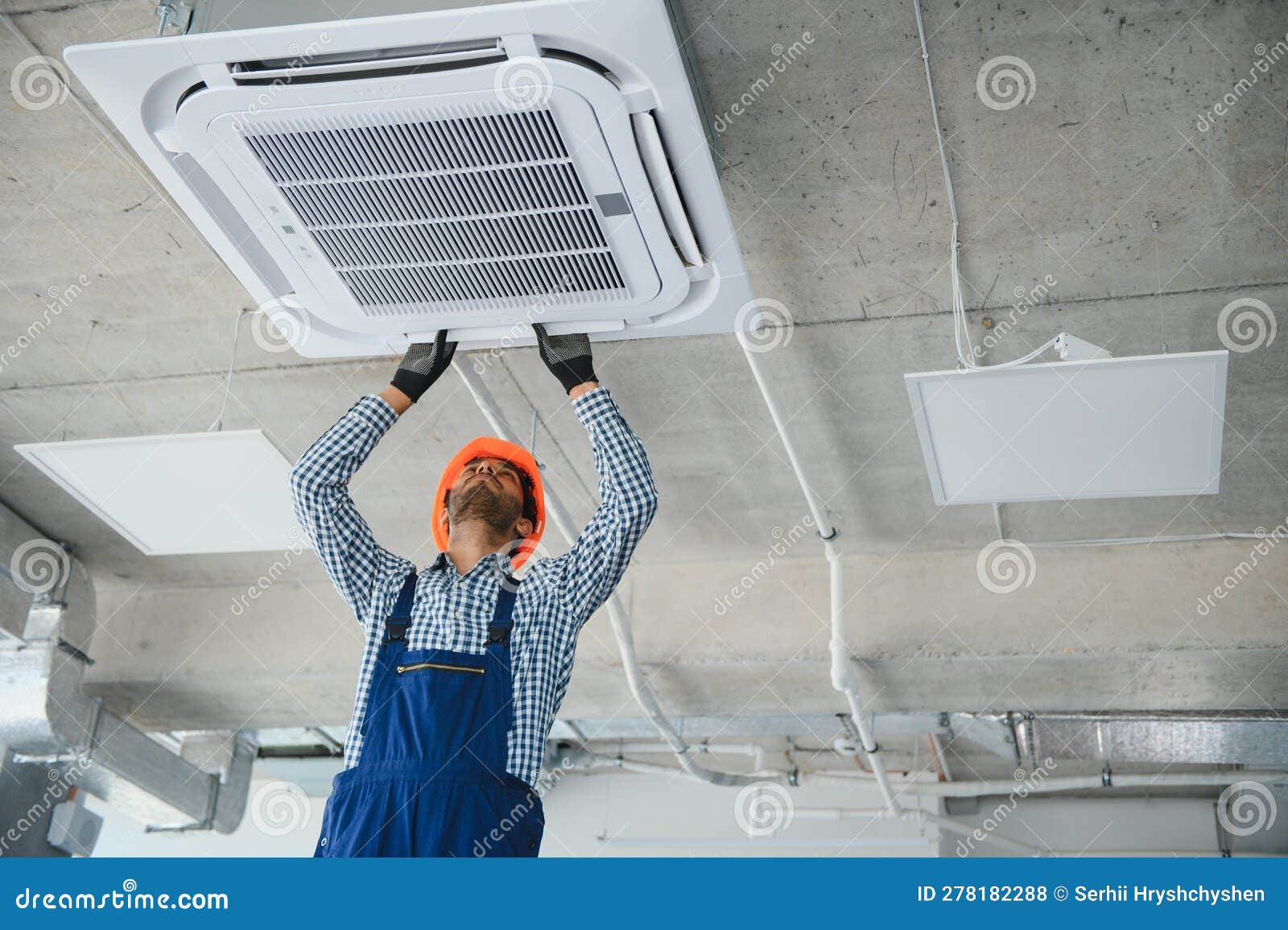 Concentrated Young Indian Engineer Setting Up Air Conditioner. Stock ...