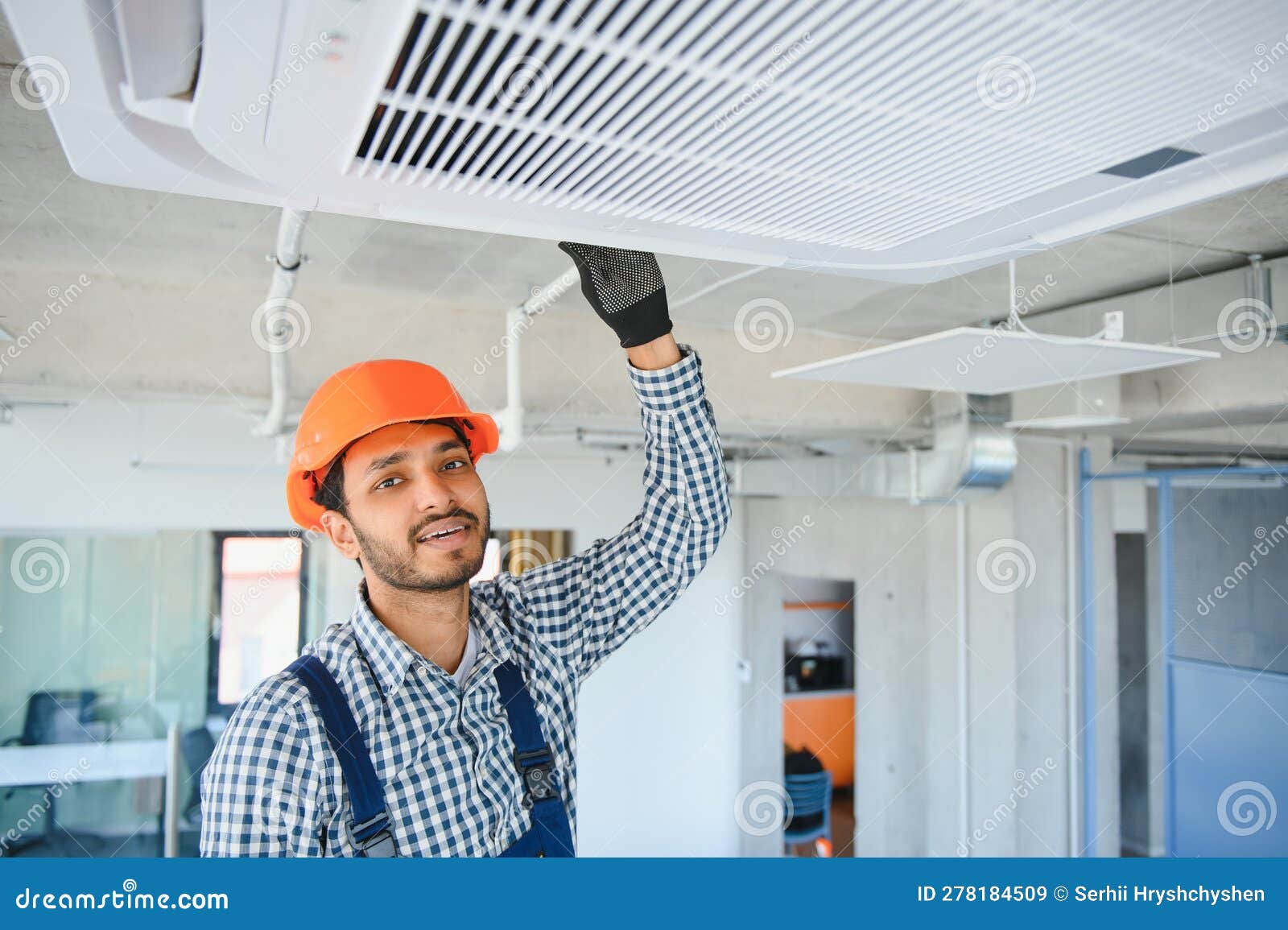 Concentrated Young Indian Engineer Setting Up Air Conditioner. Stock ...