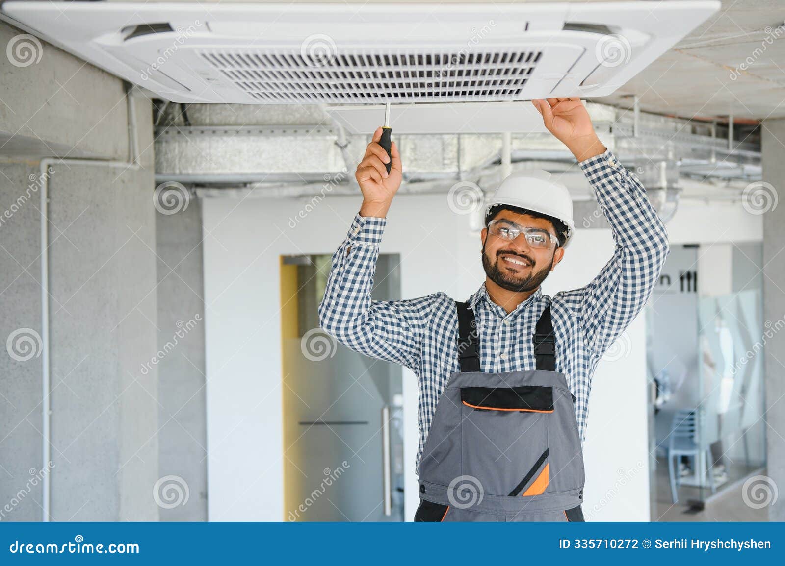 Concentrated Young Indian Engineer Setting Up Air Conditioner Stock ...