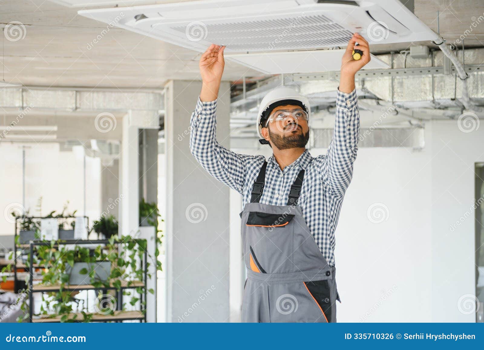 Concentrated Young Indian Engineer Setting Up Air Conditioner Stock ...