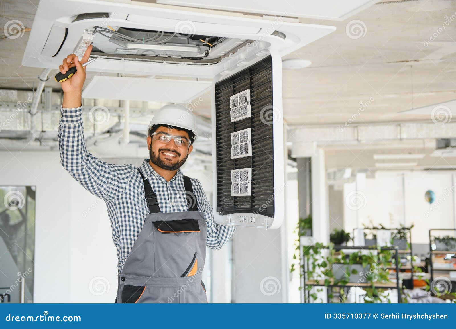 Concentrated Young Indian Engineer Setting Up Air Conditioner Stock ...