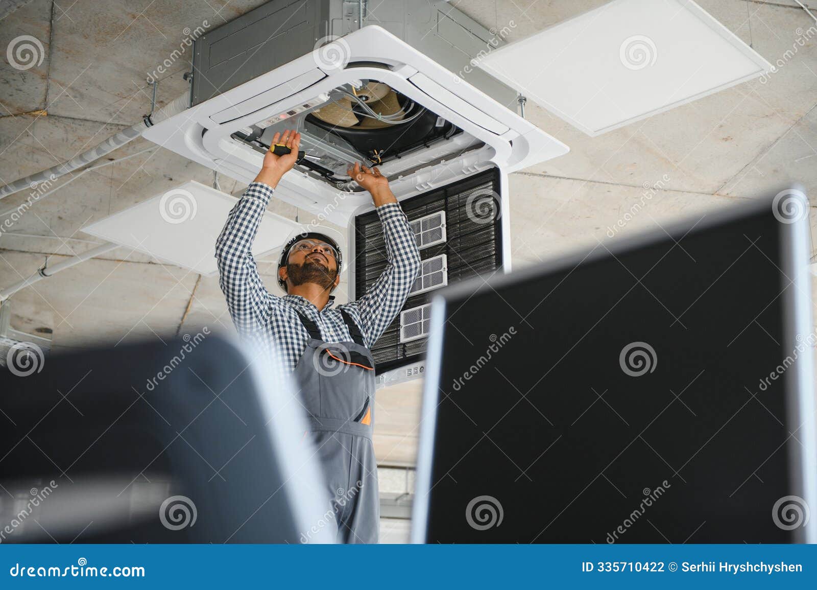 Concentrated Young Indian Engineer Setting Up Air Conditioner Stock ...