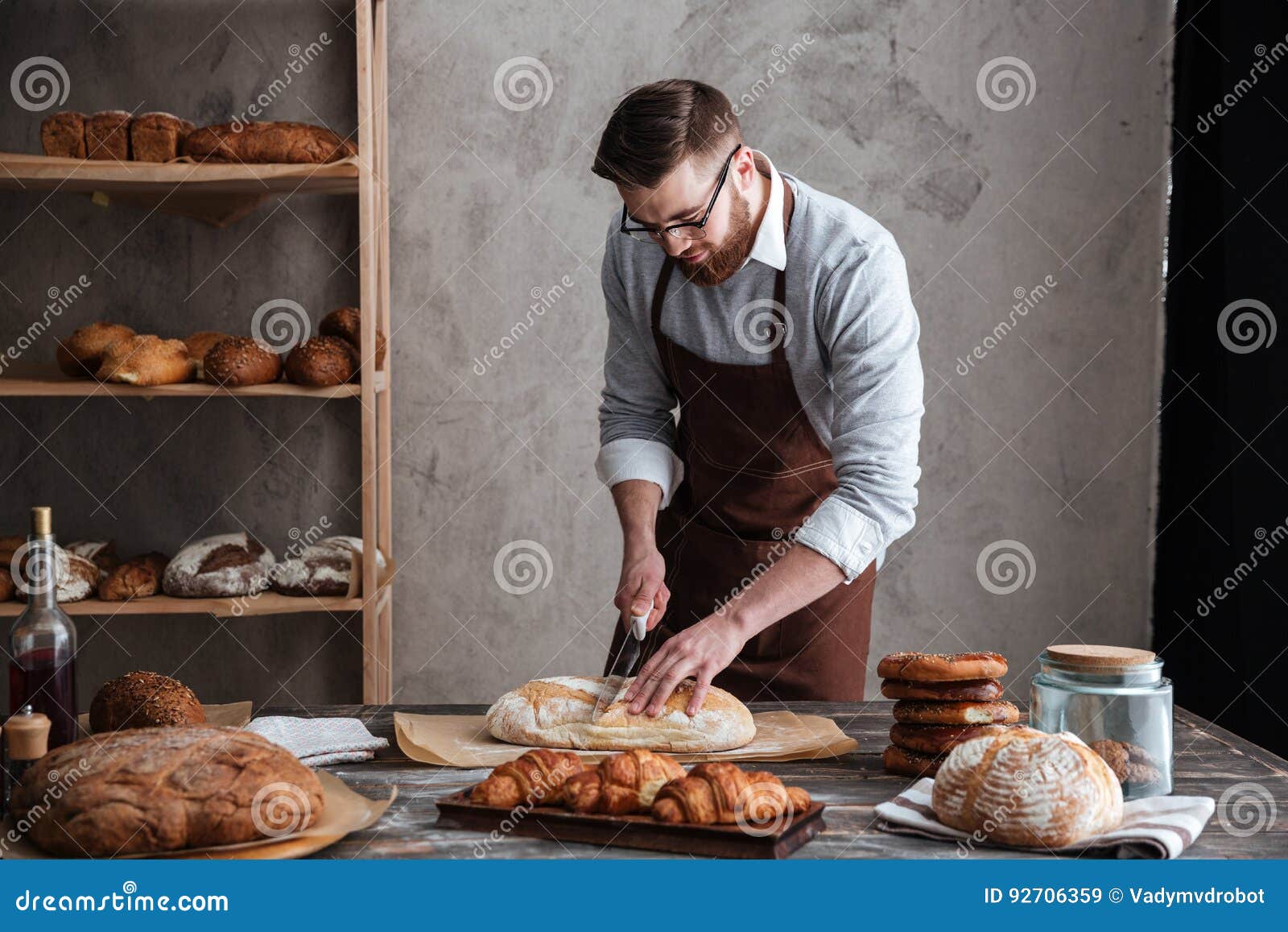 Concentrated Young Man Baker Cut the Bread. Stock Image - Image of ...