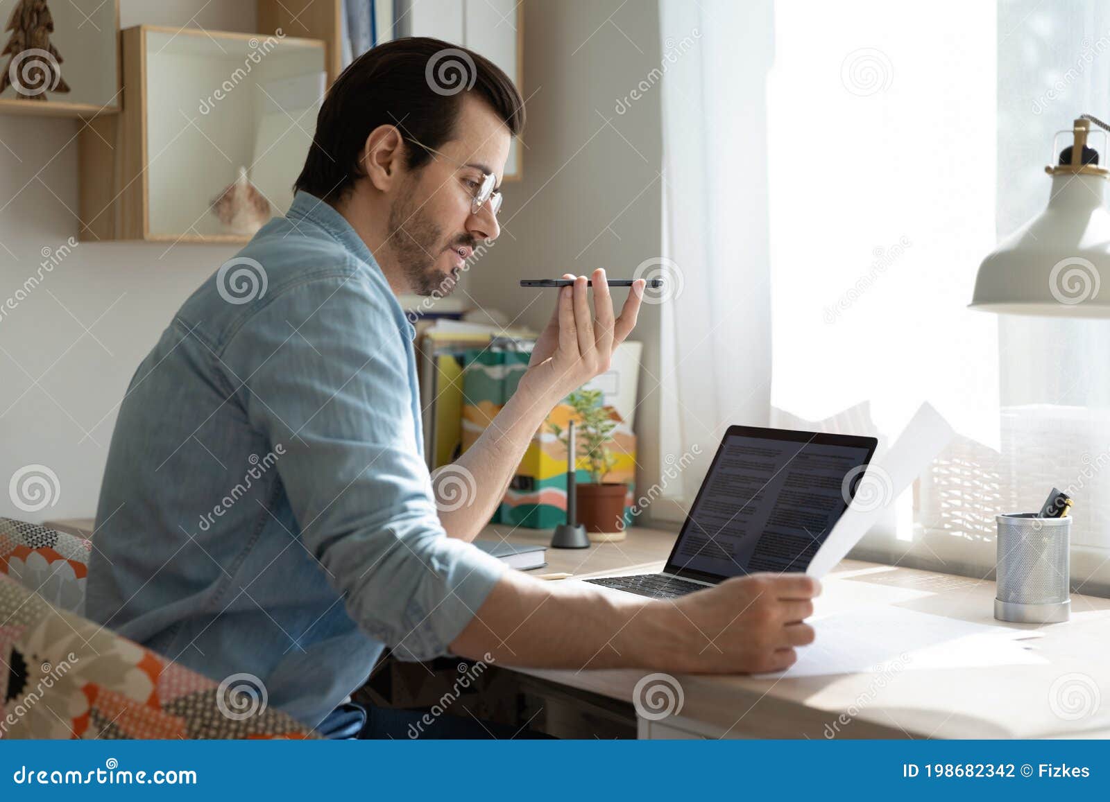 Concentrated Young Man Dictating Audio Message in Mobile Application ...